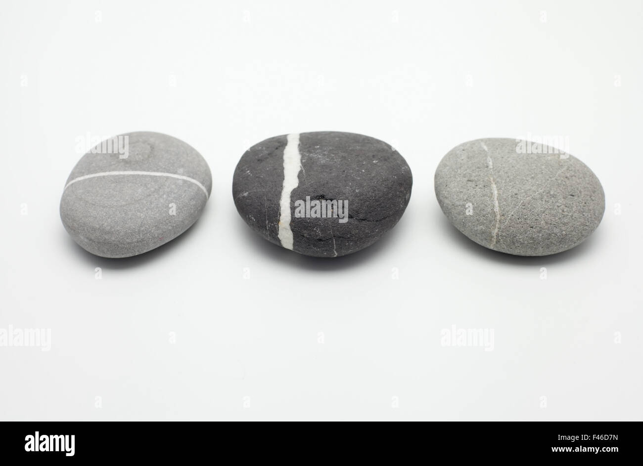 Three Zen Stones on white background Stock Photo - Alamy