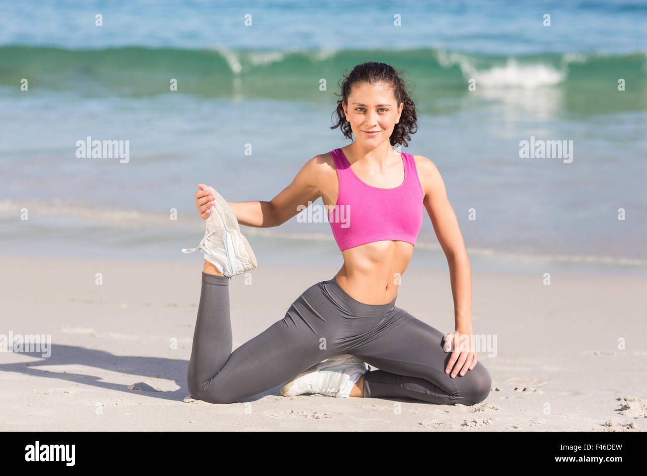 Beautiful fit woman stretching her leg Stock Photo - Alamy