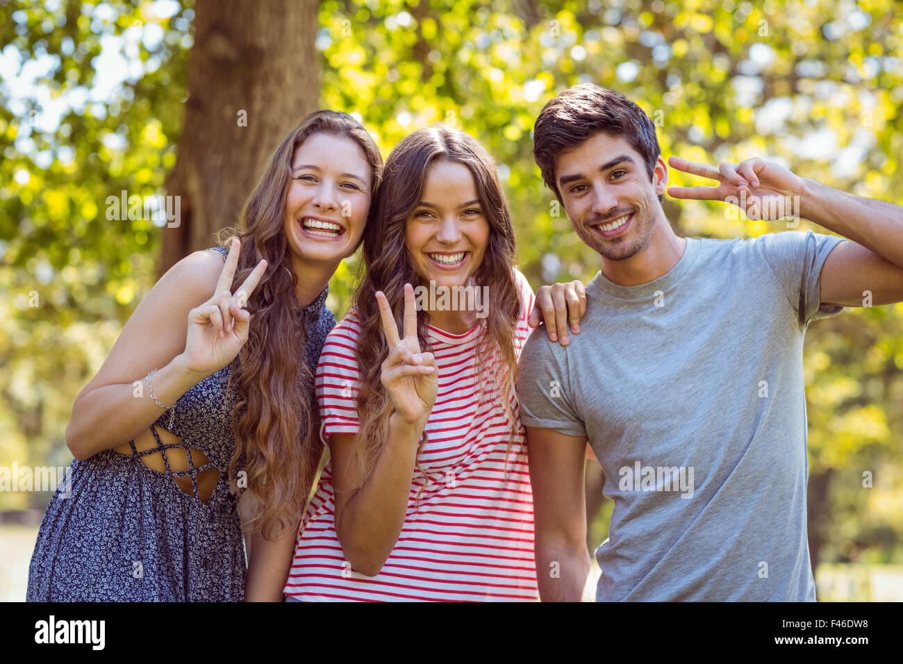 Happy friends smiling at camera Stock Photo - Alamy