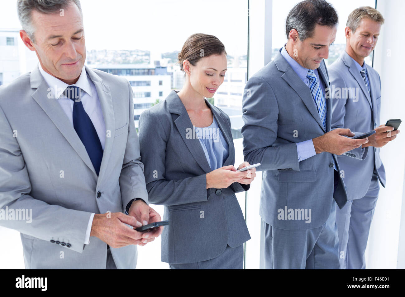 Employees using their mobile phone Stock Photo - Alamy