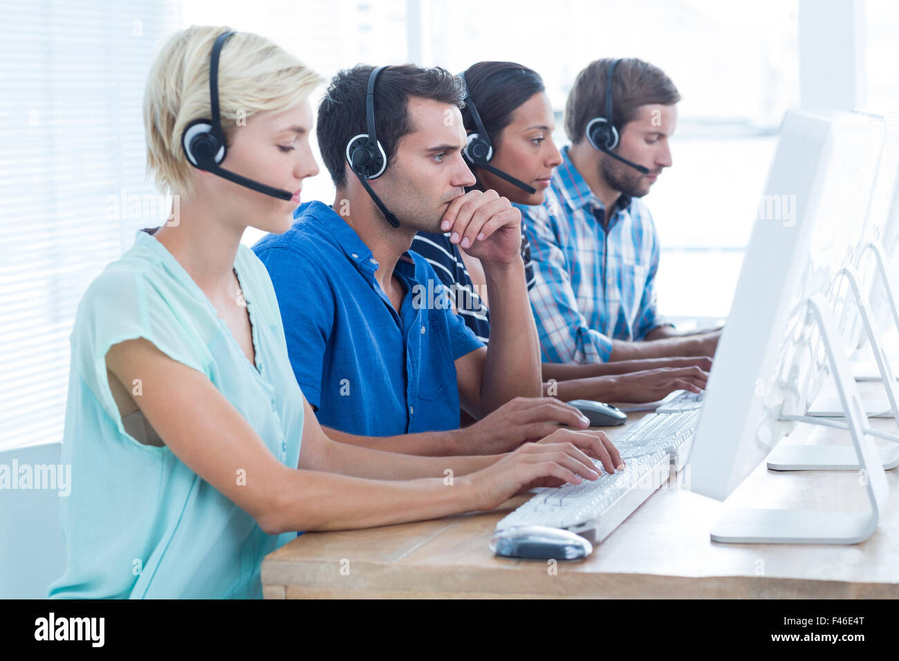 Call centre workers on their laptops Stock Photo - Alamy