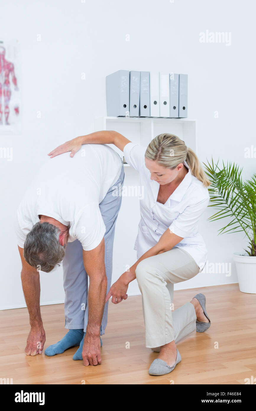 Doctor examining her patient back Stock Photo - Alamy
