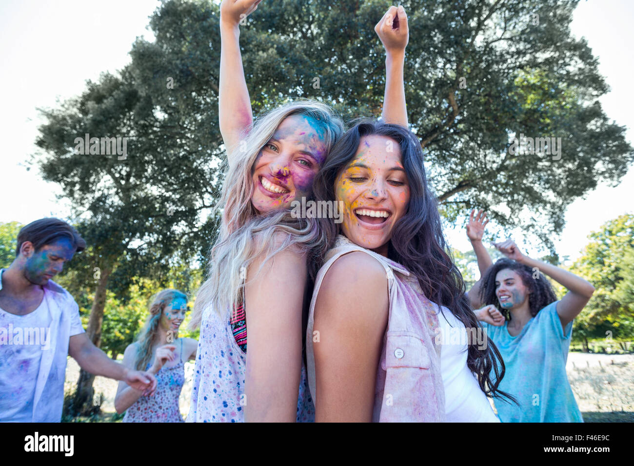 Happy friends covered in powder paint Stock Photo - Alamy