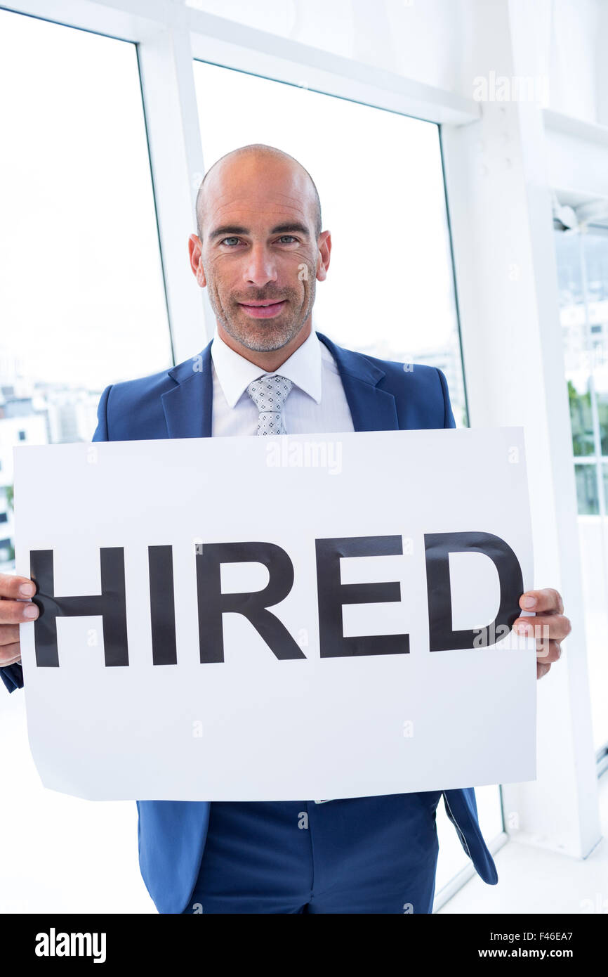 businessman holding a hired sign Stock Photo - Alamy