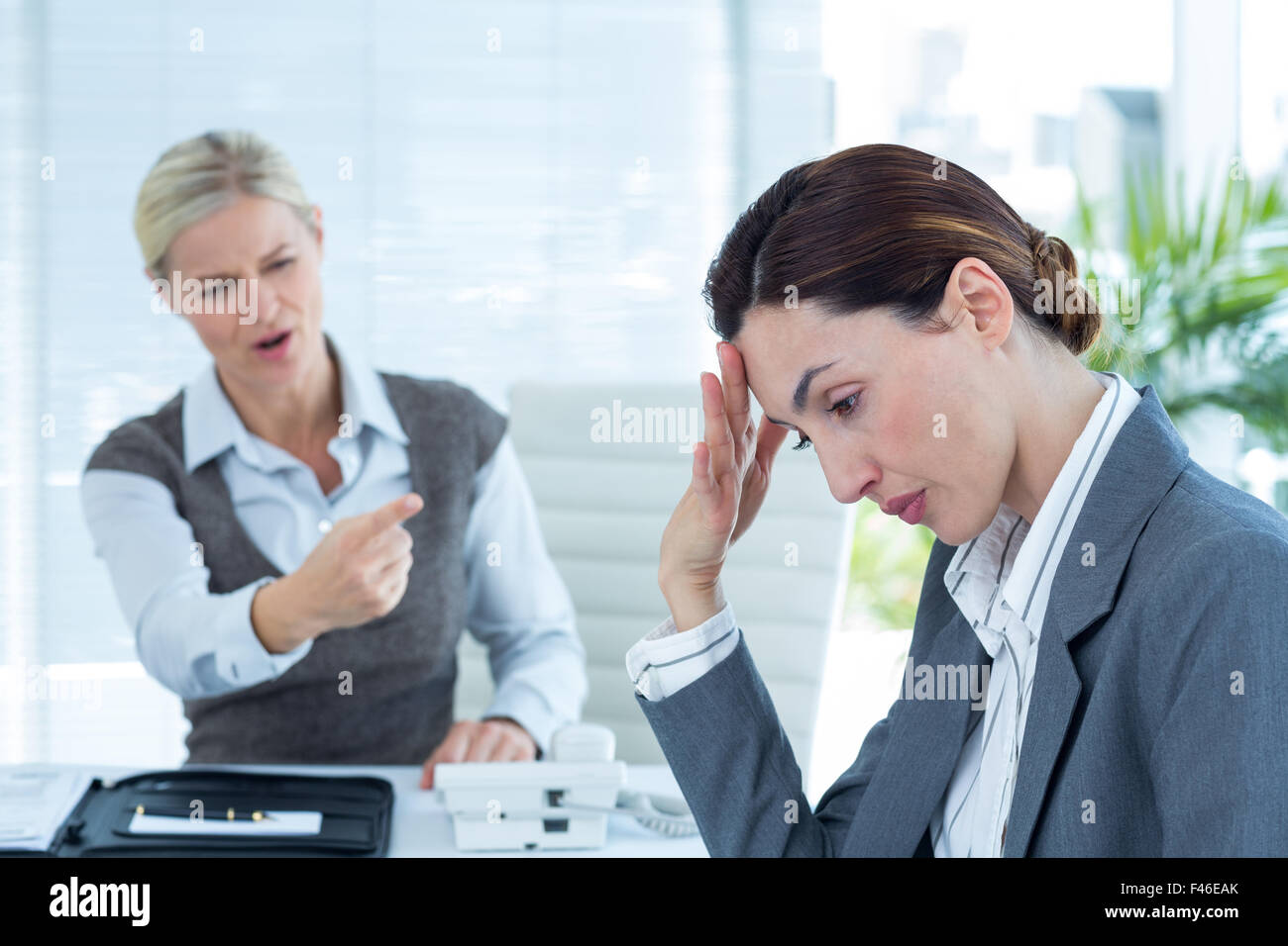 Businesswoman yelling at colleague Stock Photo - Alamy