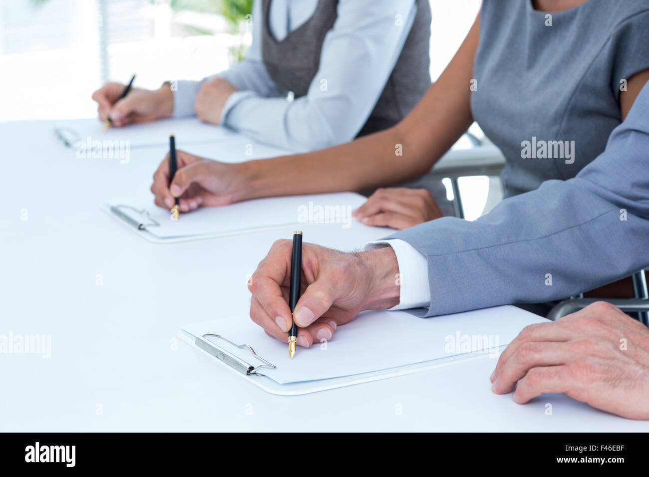 Group of business people taking notes Stock Photo - Alamy