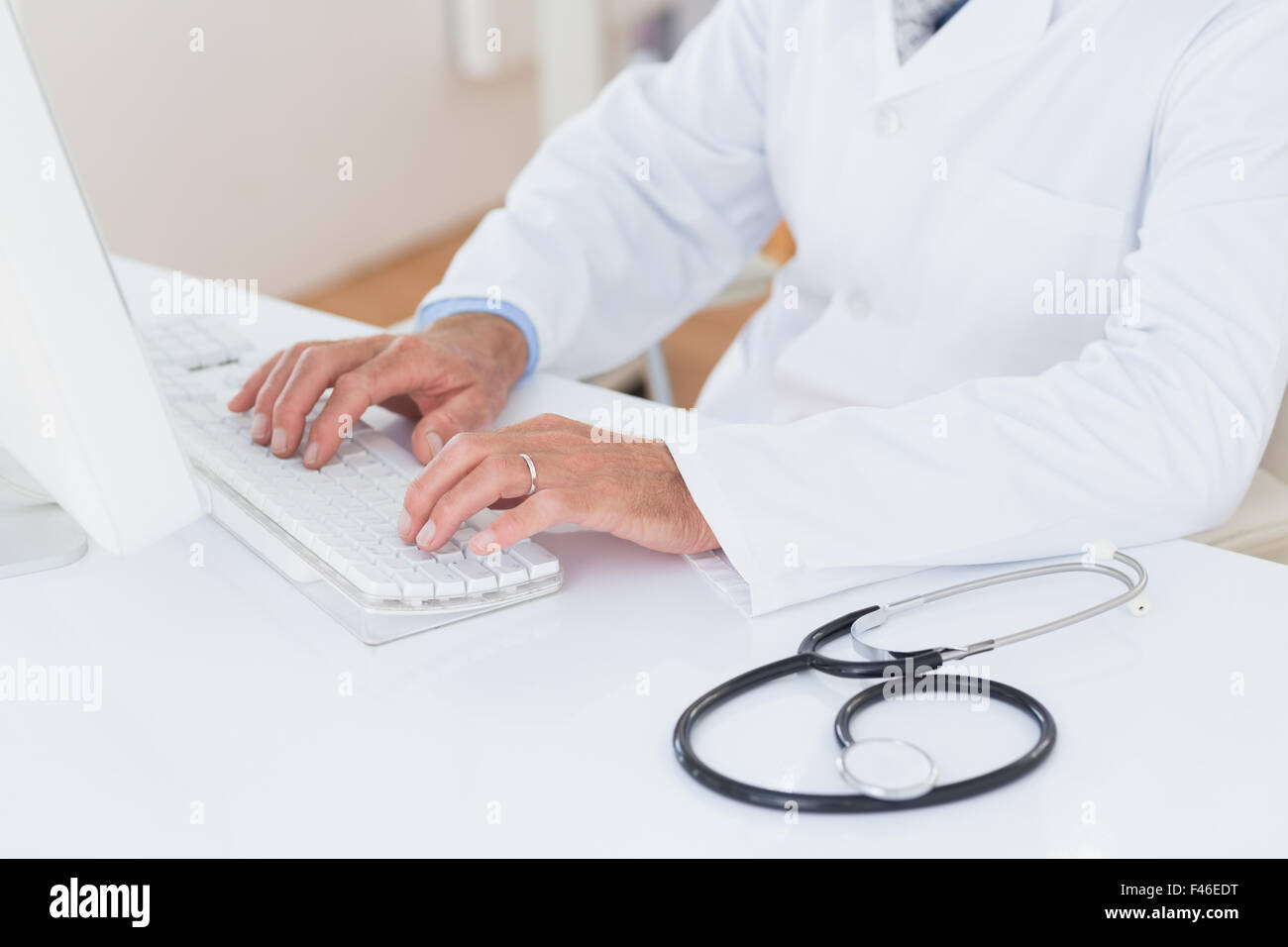 Concentrating doctor using computer Stock Photo - Alamy