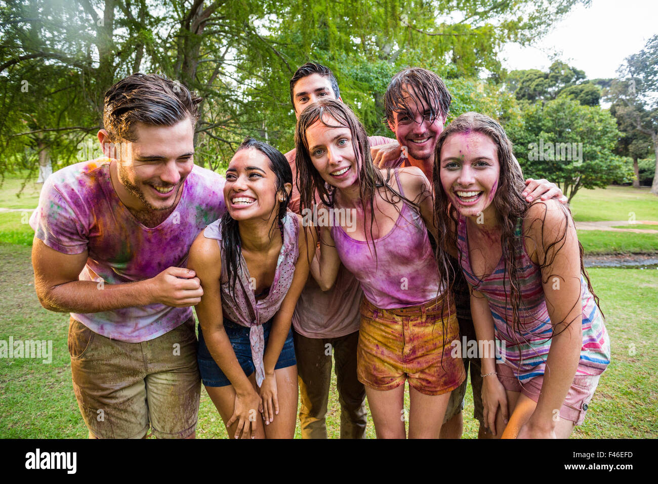 Happy friends covered in powder paint Stock Photo - Alamy