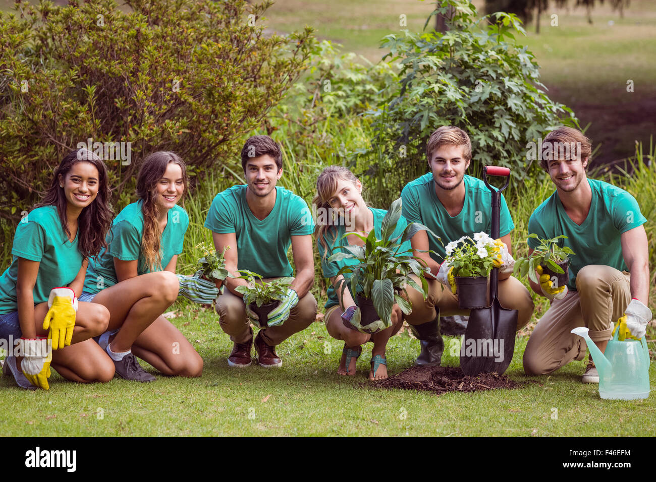 Happy friends gardening for the community Stock Photo - Alamy