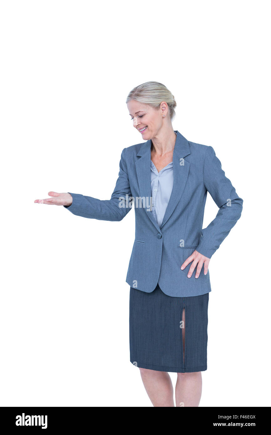 Smiling businesswoman presenting with hand Stock Photo - Alamy