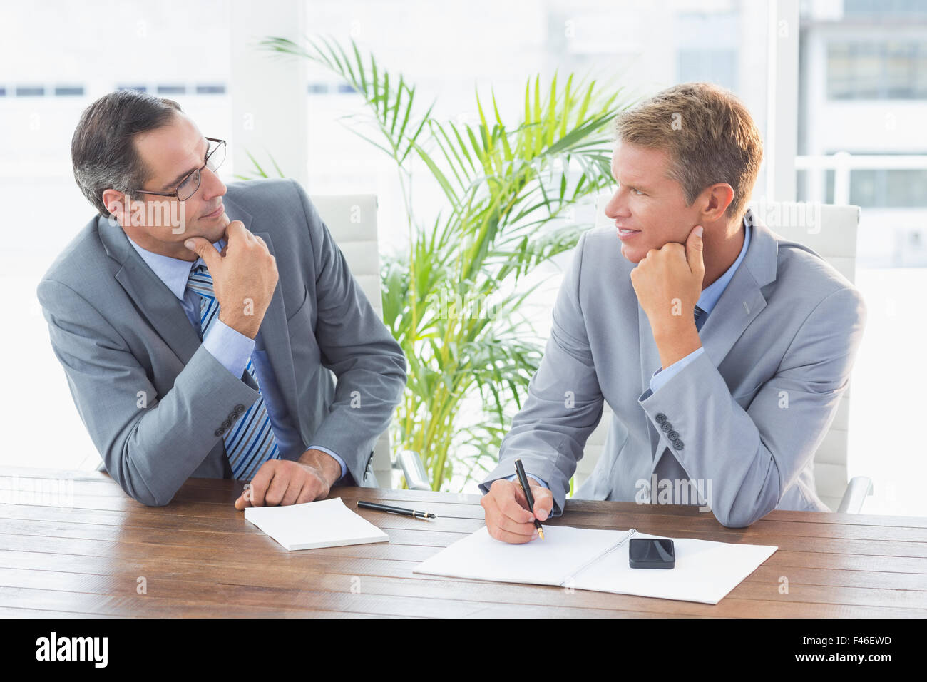 Businessmen working together Stock Photo - Alamy