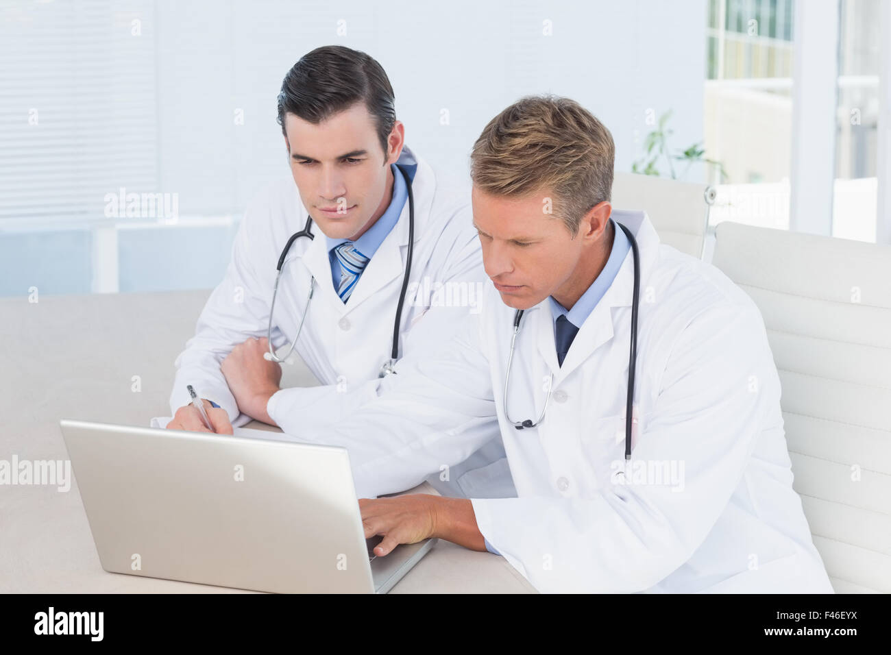 Concentrated doctors working with computer Stock Photo - Alamy