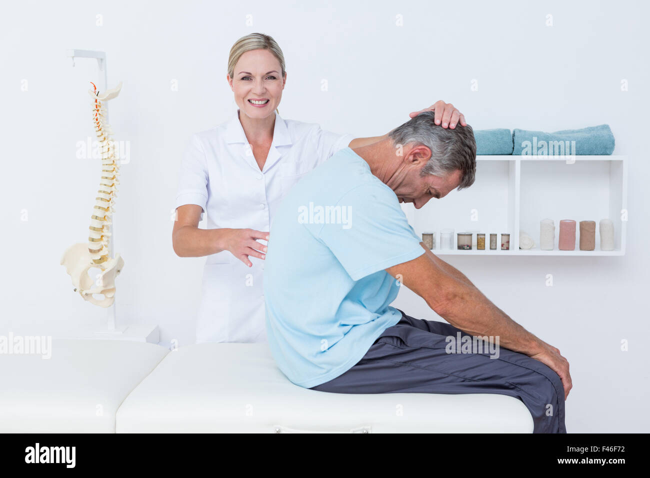 Doctor stretching a man back Stock Photo - Alamy