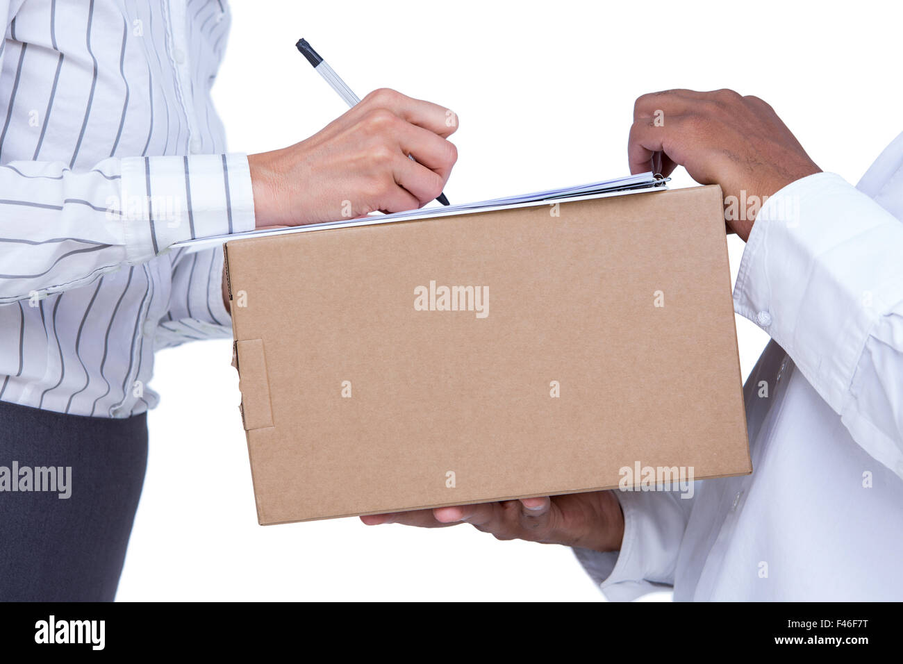 Businesswoman signing papers for package Stock Photo - Alamy