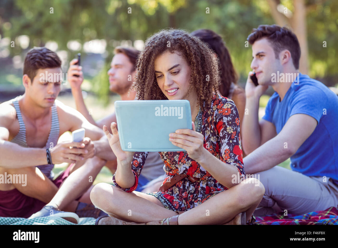 Cute curly hair girl using a tablet Stock Photo - Alamy