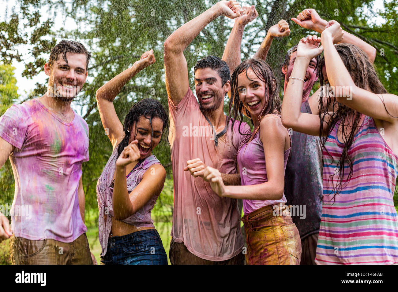 Happy friends covered in powder paint Stock Photo - Alamy