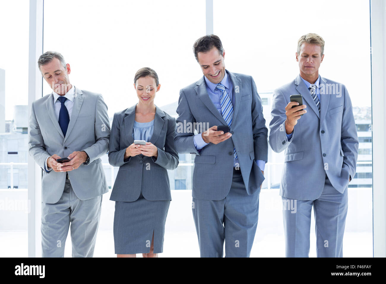 Employees using their mobile phone Stock Photo - Alamy