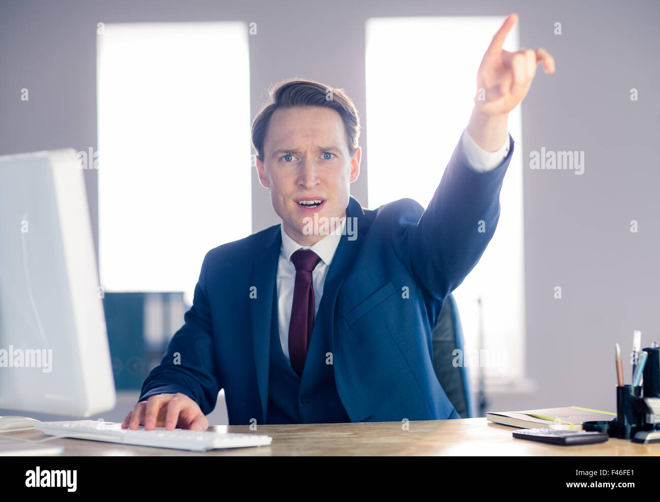 Angry businessman pointing and shouting Stock Photo - Alamy