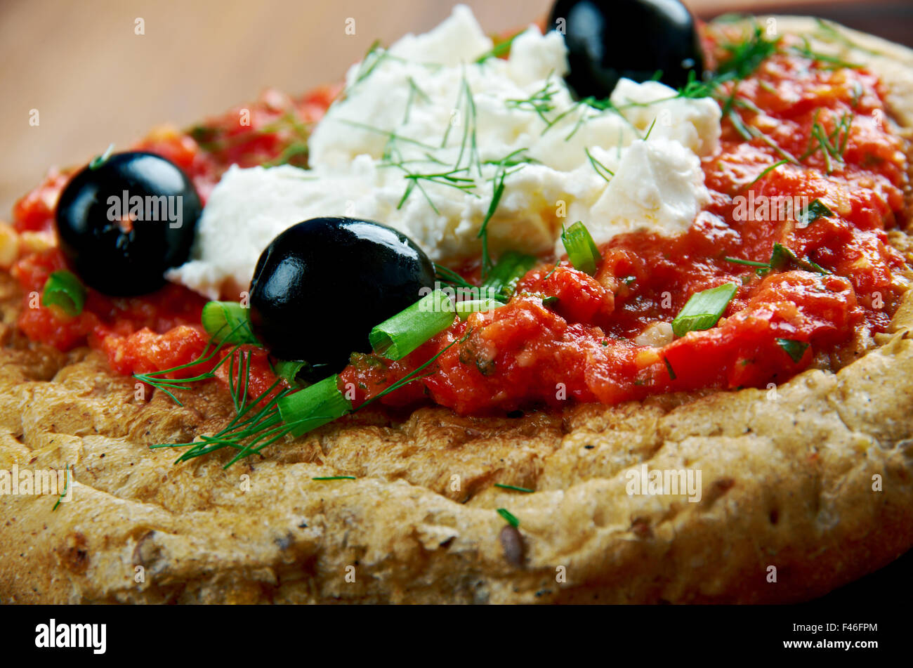 Dakos - slice bread topped with chopped tomatoes and crumbled feta ...