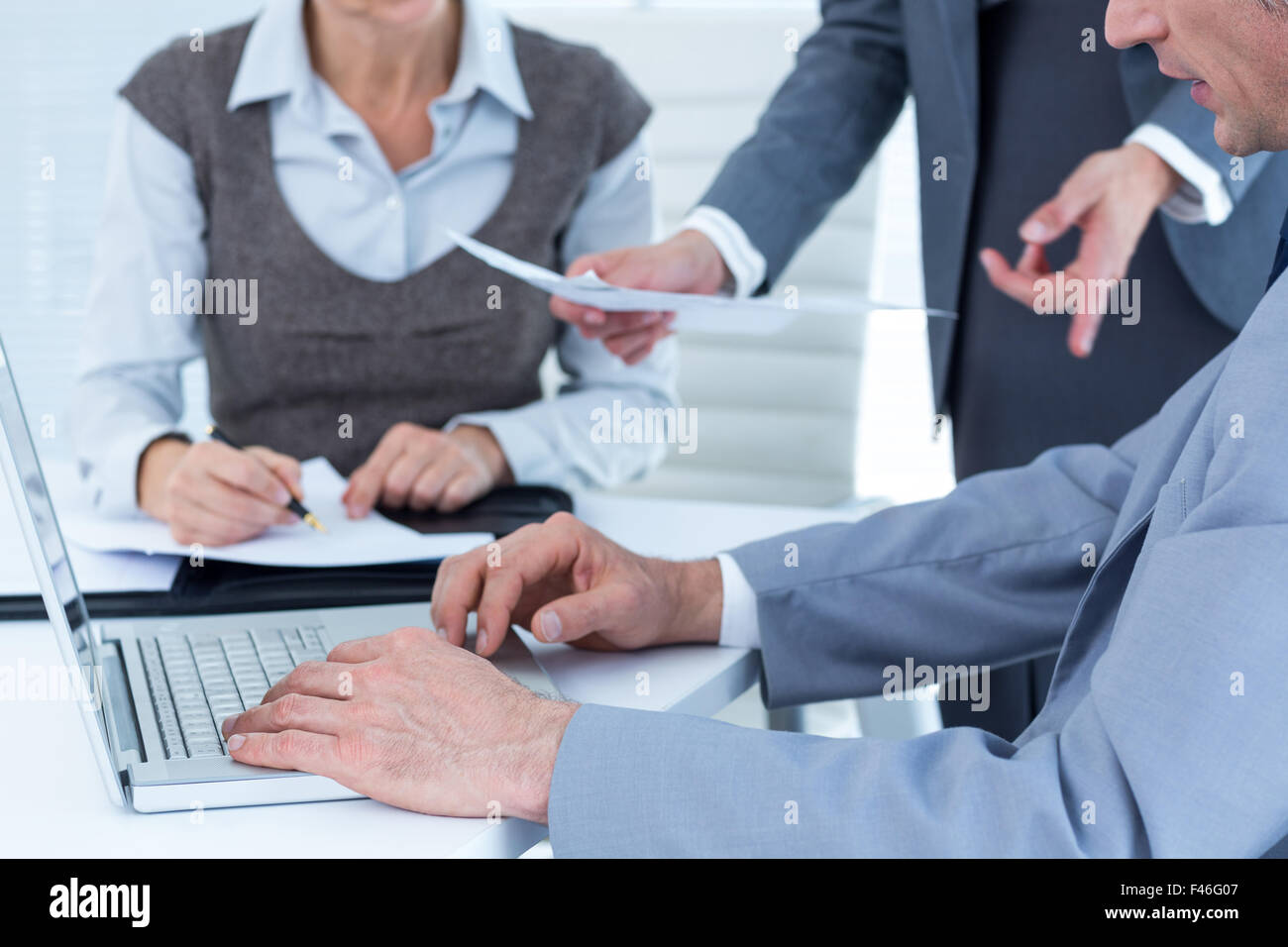 Business people using laptop Stock Photo - Alamy