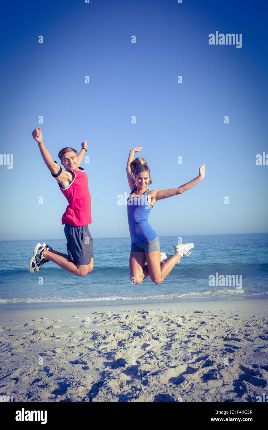 Happy couple jumping together Stock Photo - Alamy