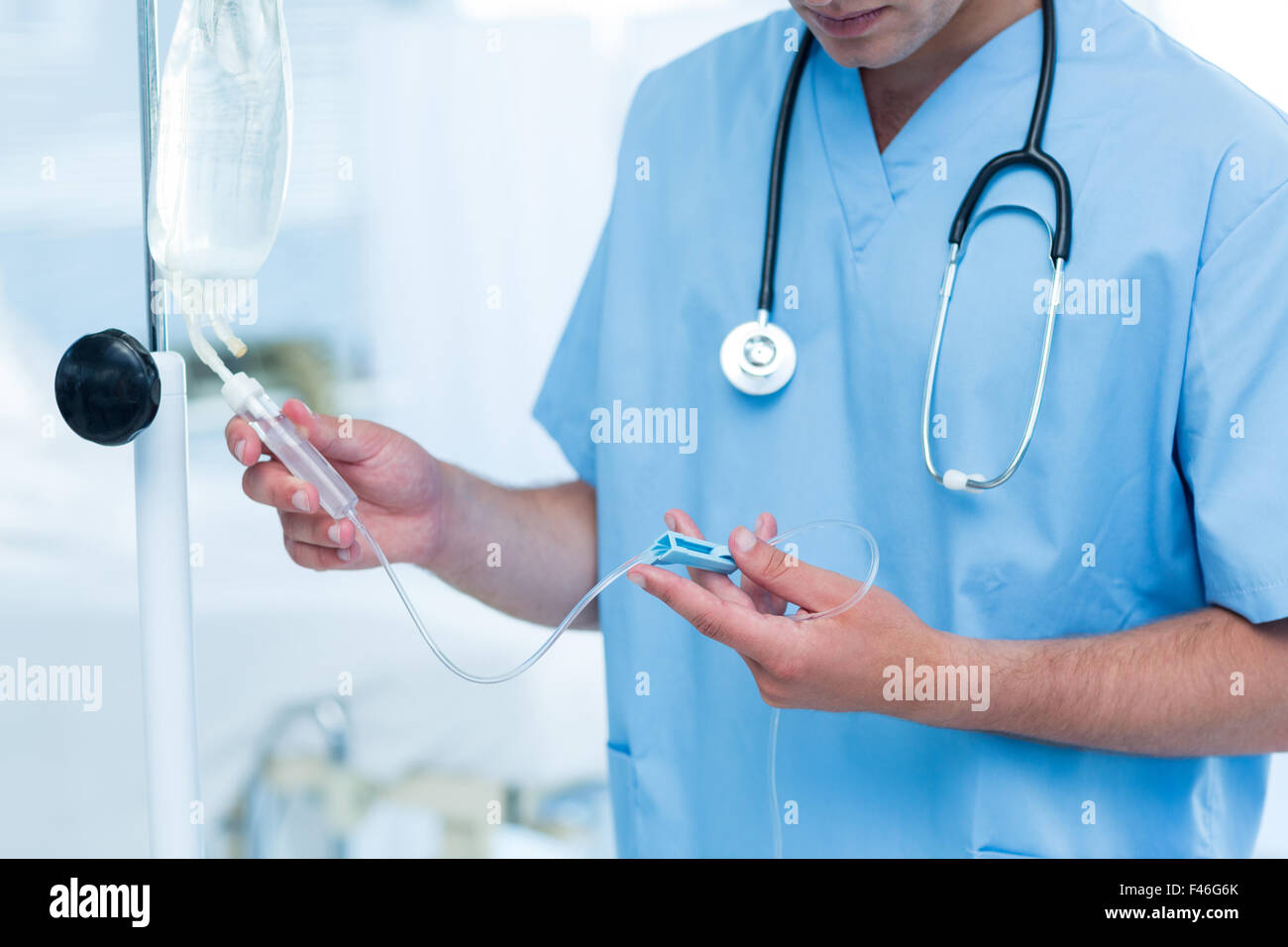 Doctor examining intravenous drip Stock Photo - Alamy