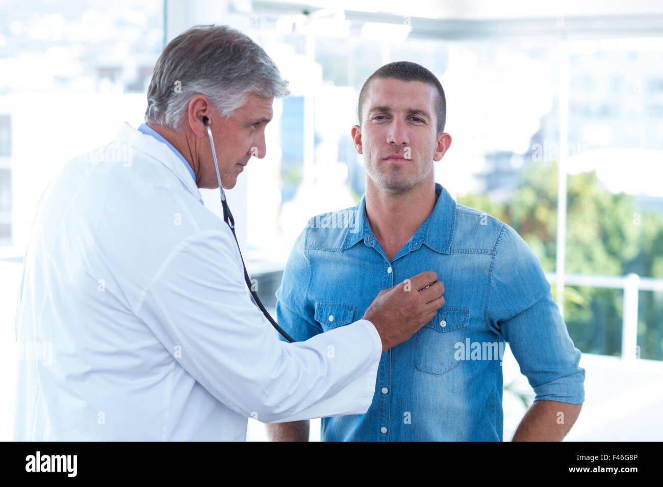 Male doctor listening patients hi-res stock photography and images - Alamy