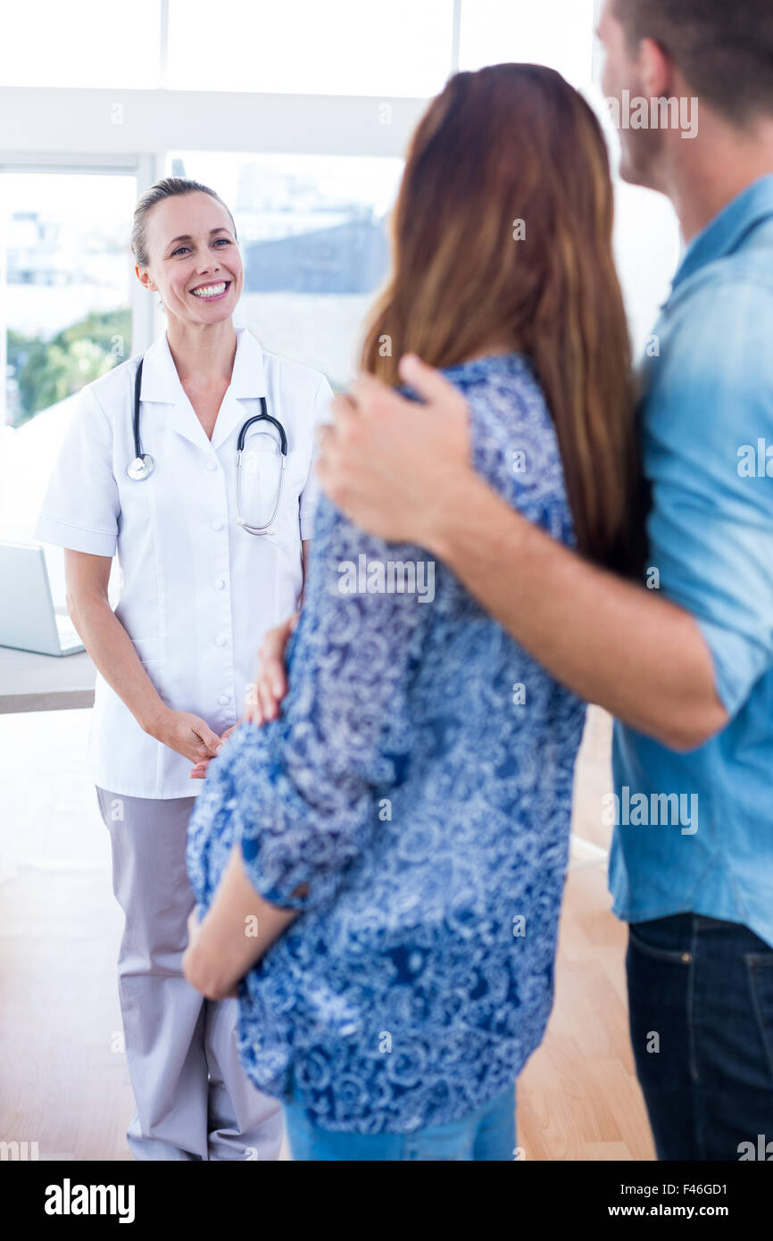Smiling obstetrician and happy couple Stock Photo - Alamy
