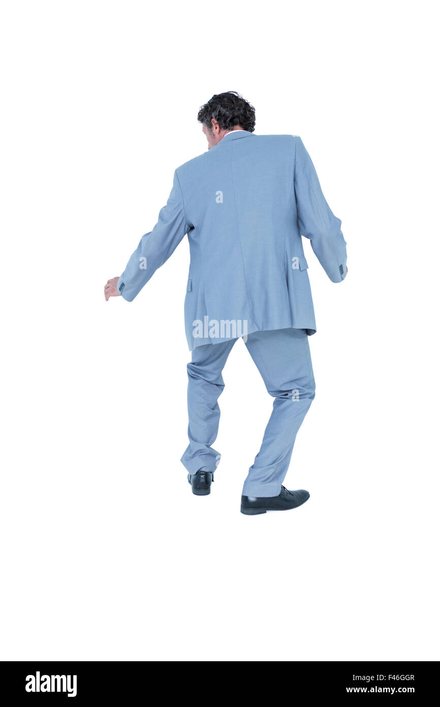 Rear view of happy businessman gesturing Stock Photo - Alamy
