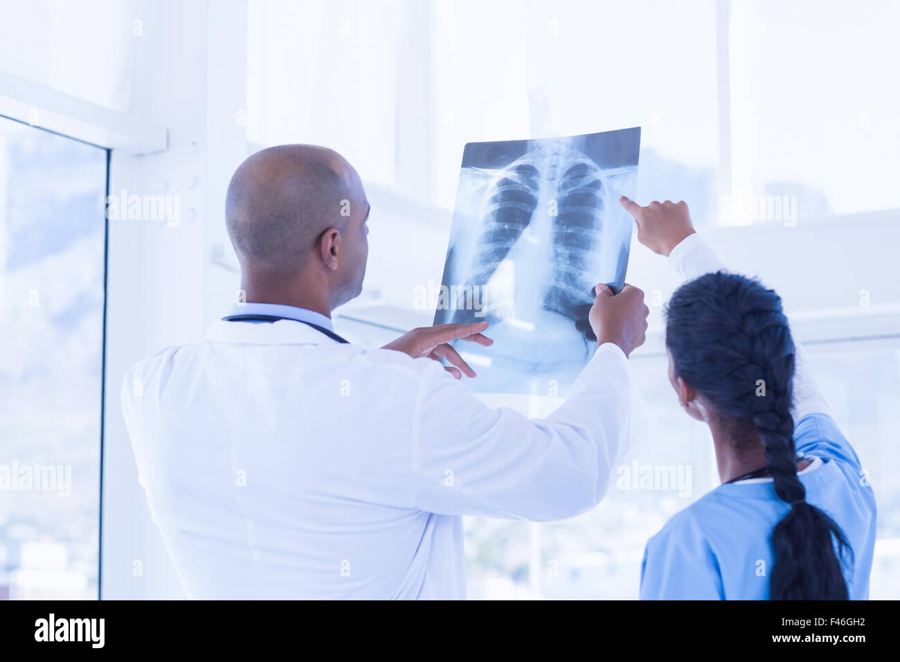 Doctors analyzing together xray Stock Photo - Alamy