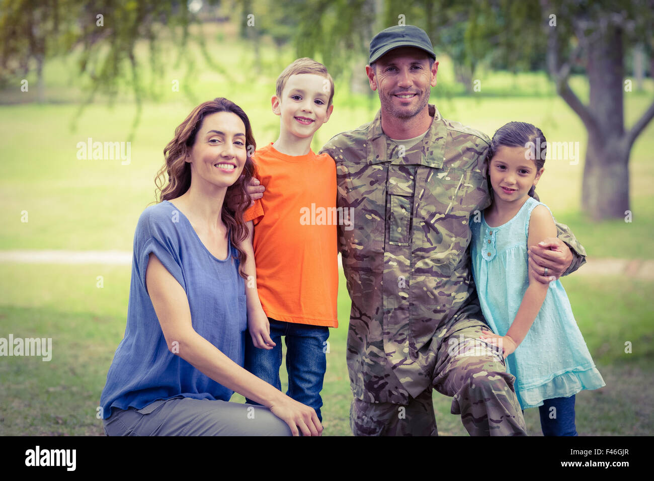 Handsome soldier reunited with family Stock Photo - Alamy