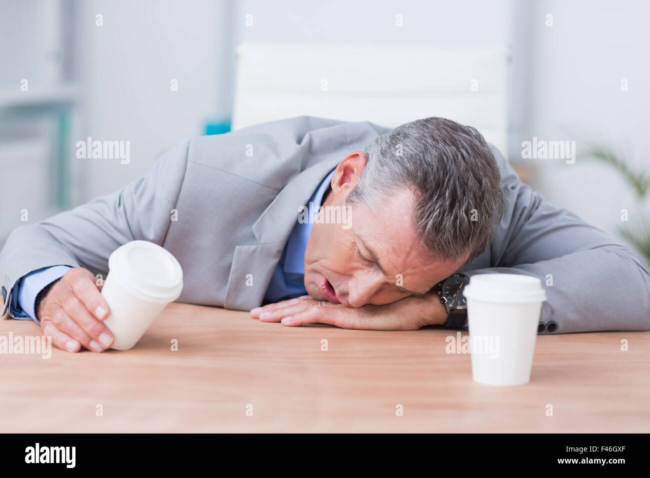 Sleeping businessman in his office Stock Photo - Alamy