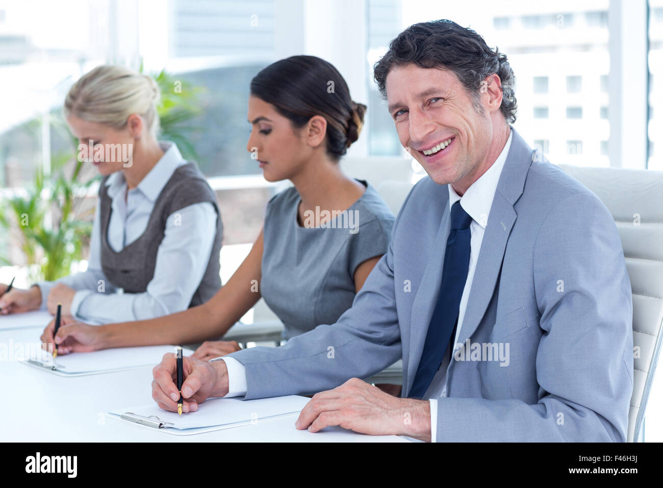 Group of business people taking notes Stock Photo - Alamy