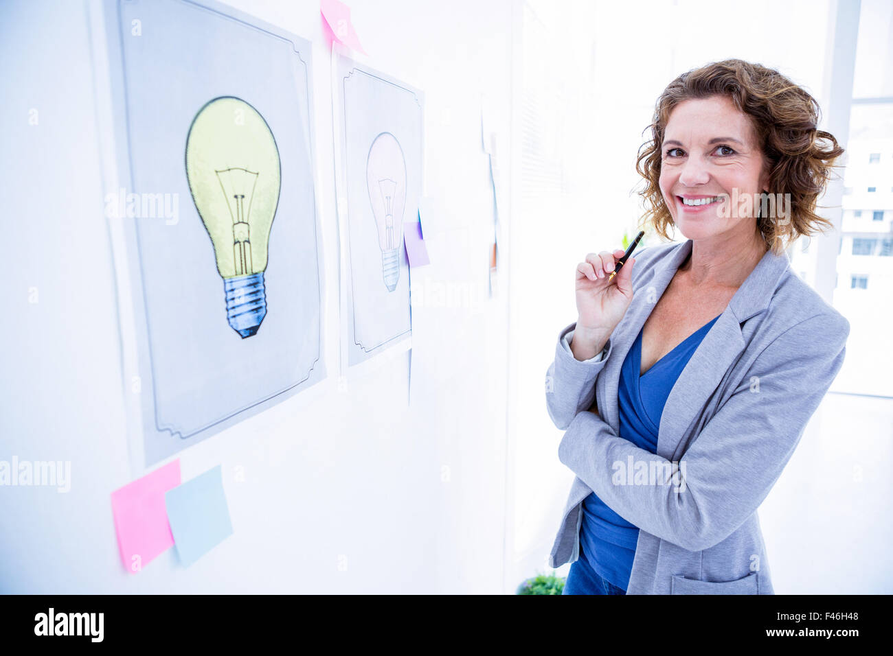 Creative business woman looking at camera Stock Photo - Alamy