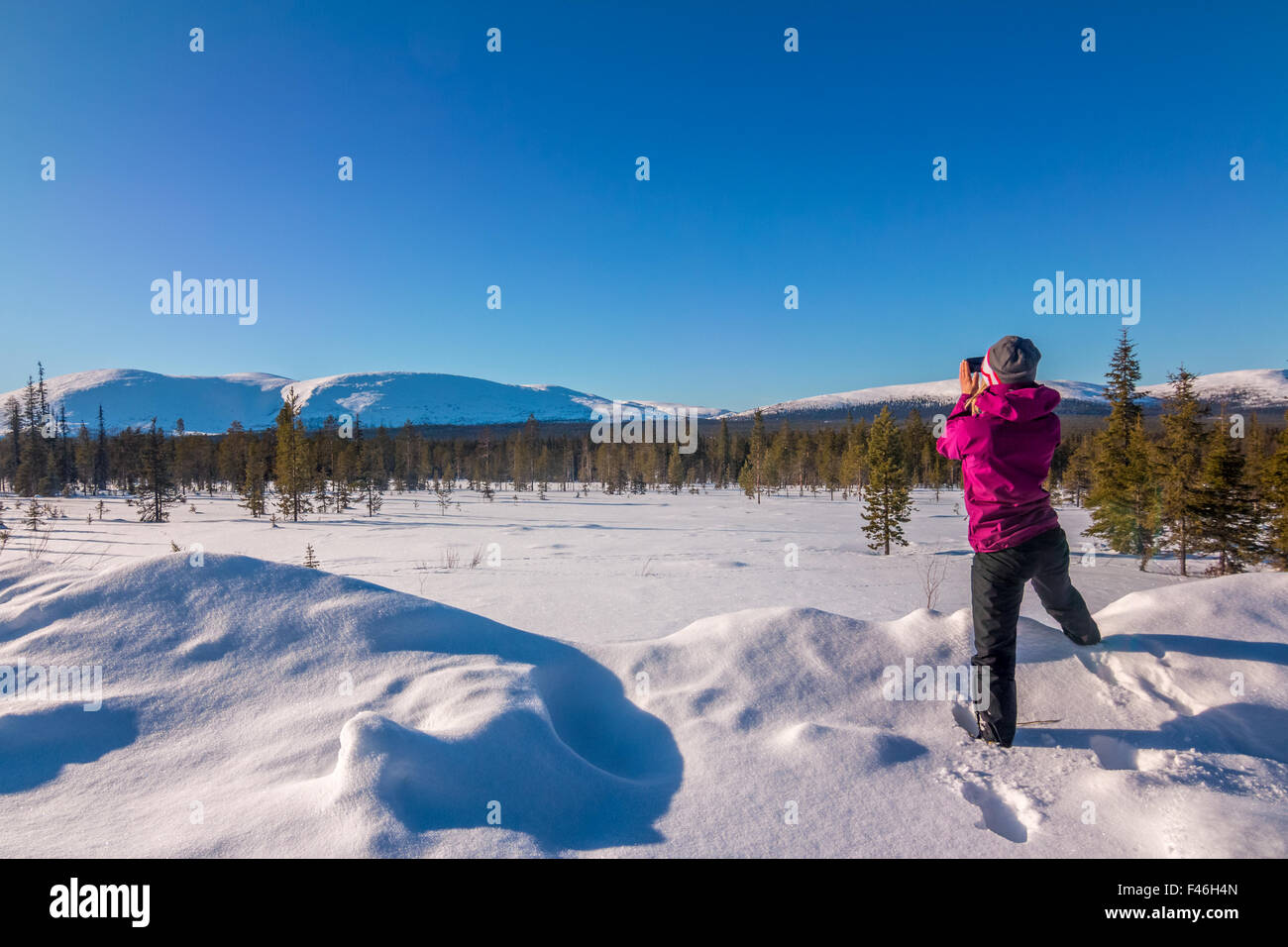 Young woman photographing with a mobile phone Stock Photo - Alamy