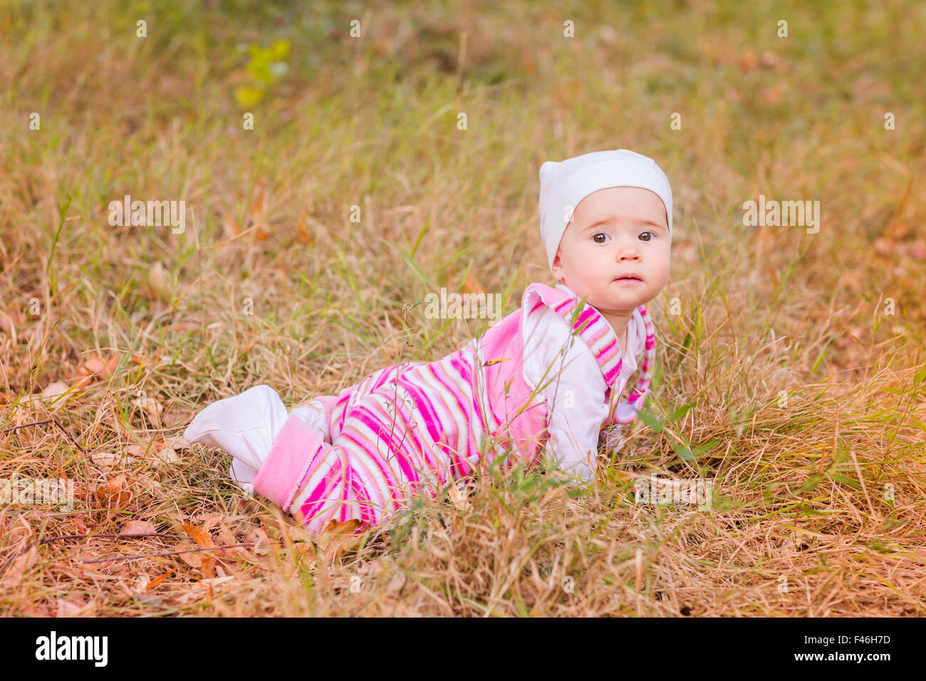 Cute baby girl in autumn leaves. First autumn Stock Photo - Alamy