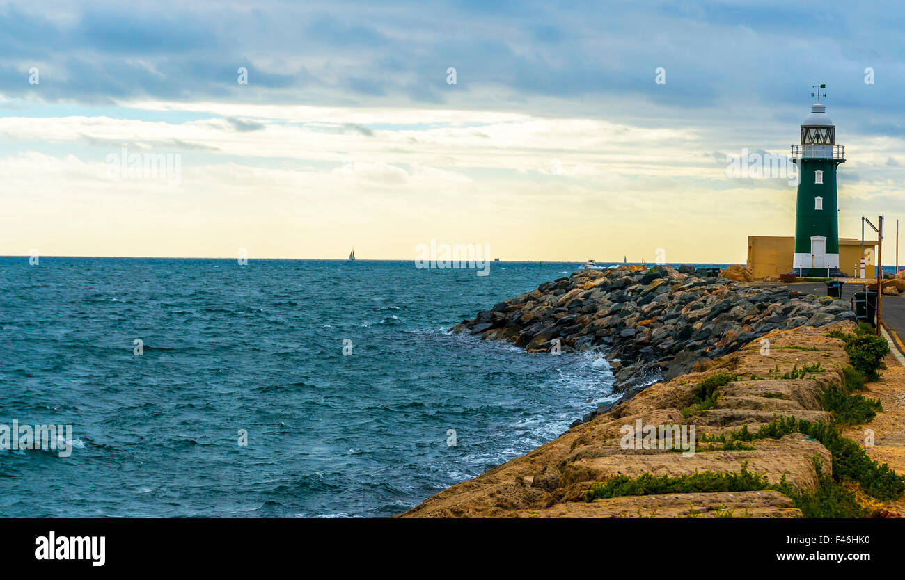 Beautiful lighthouse by the ocean at sunset Stock Photo - Alamy