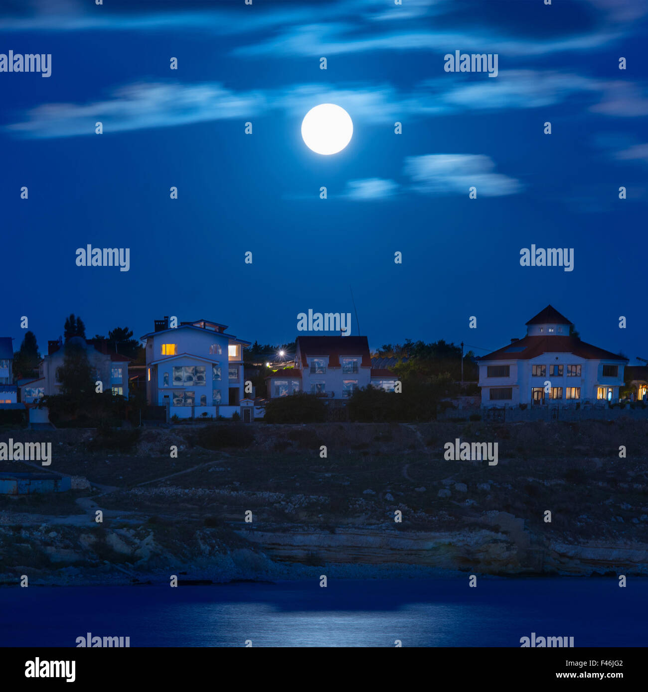 Moon over the town Stock Photo - Alamy