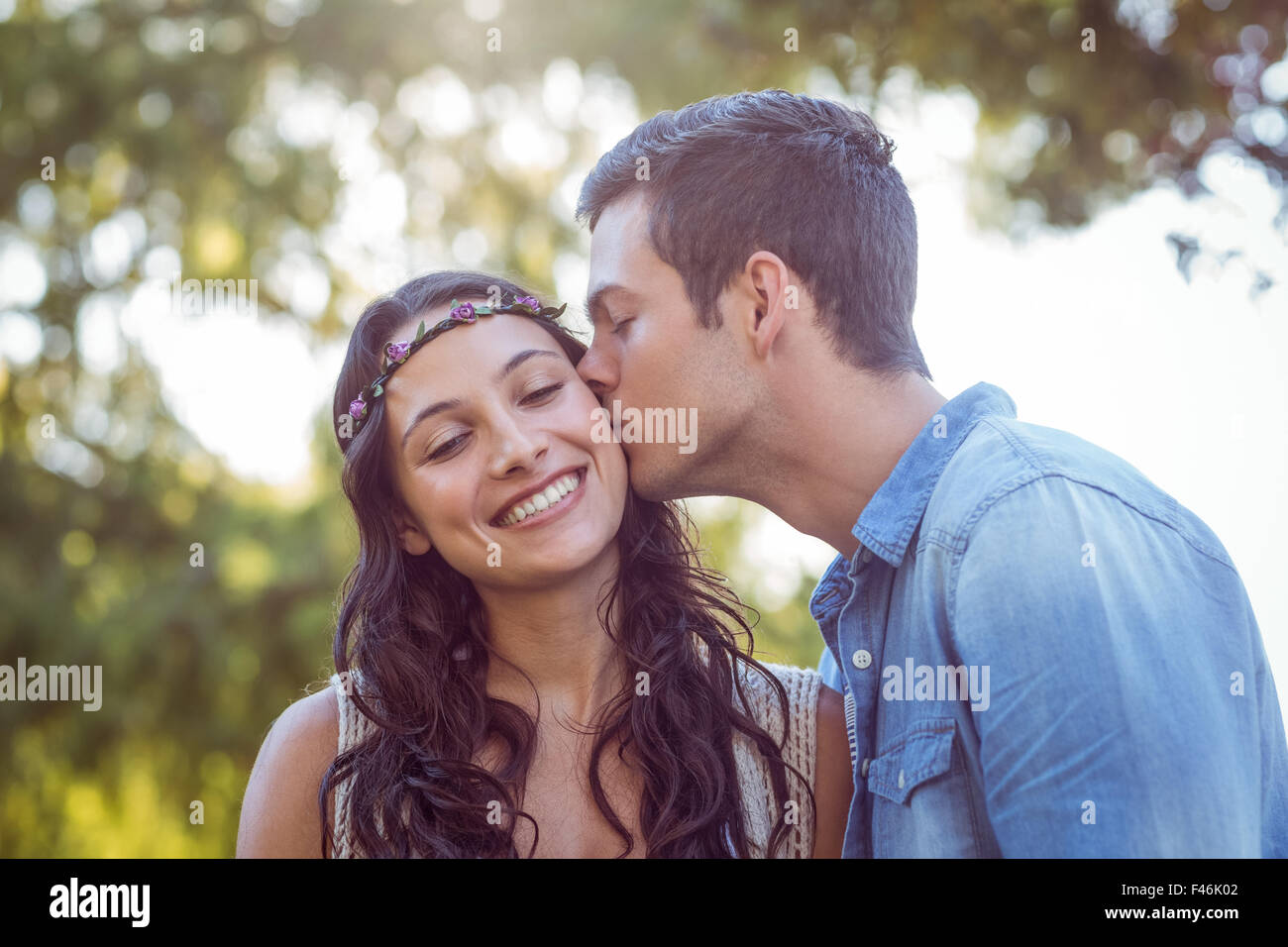 Cute couple kissing in the park Stock Photo - Alamy