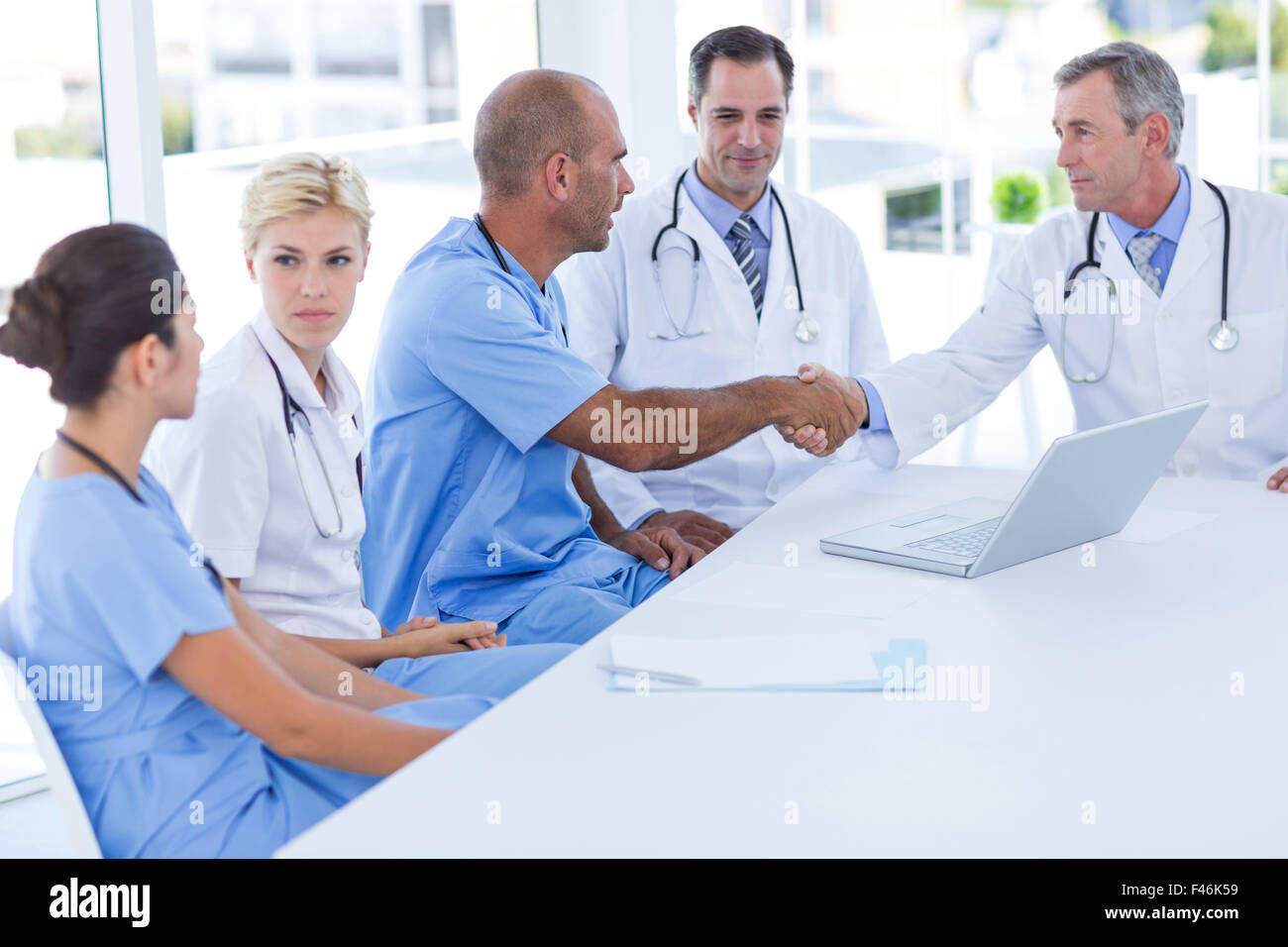 Confident woman shakes hands hi-res stock photography and images - Alamy