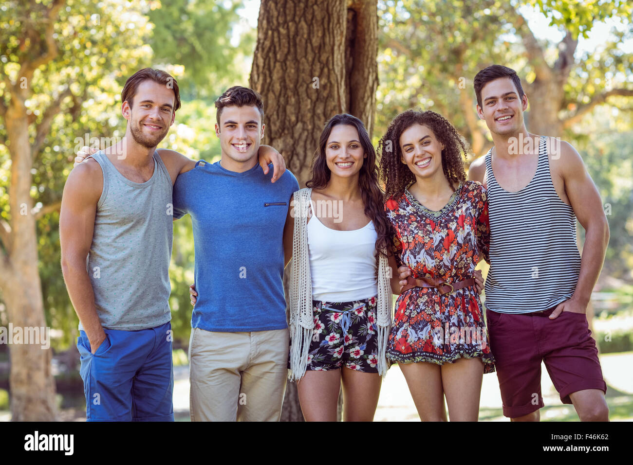 Friends smiling to the camera Stock Photo - Alamy