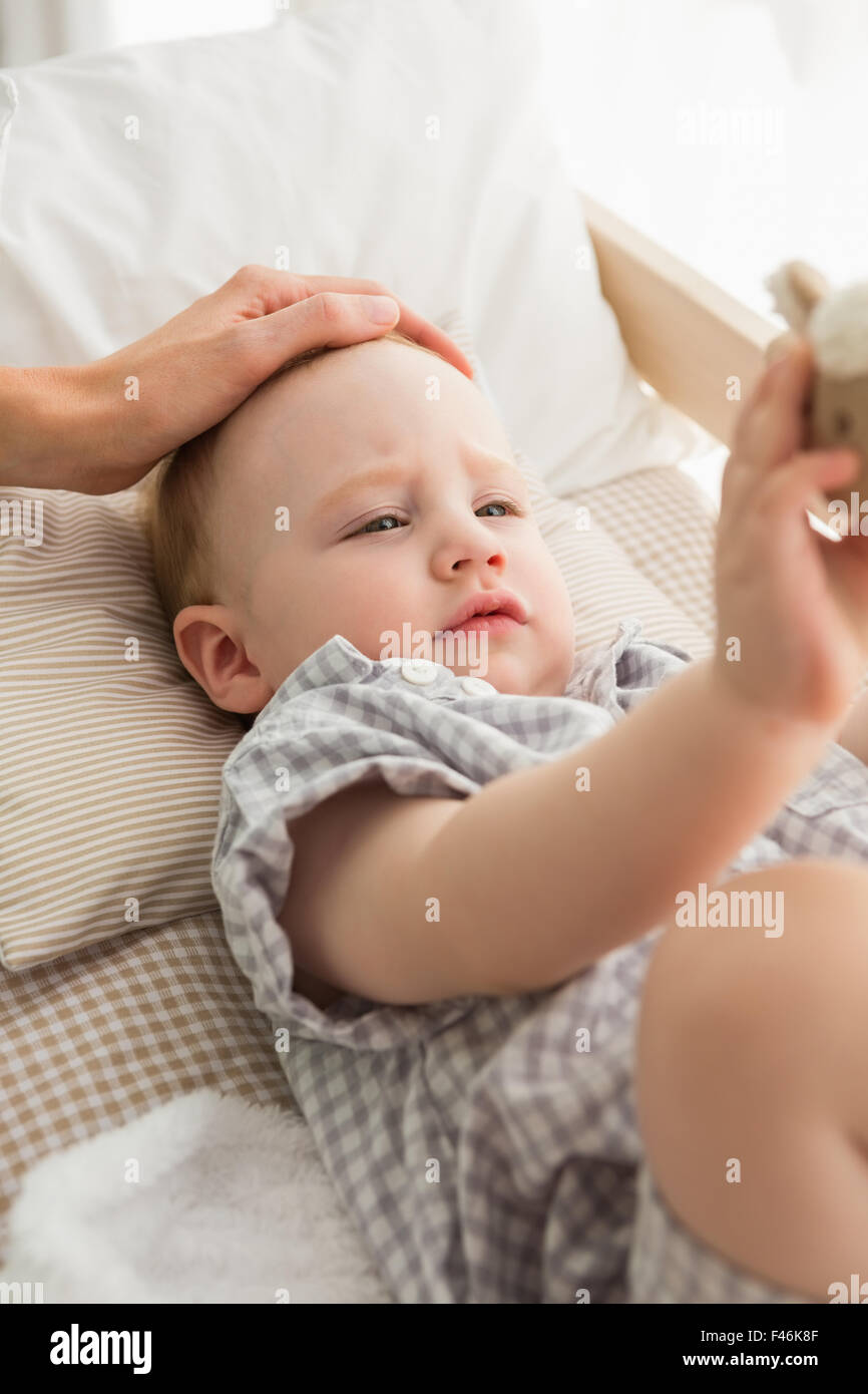 Mother touching baby forehead hi-res stock photography and images - Alamy