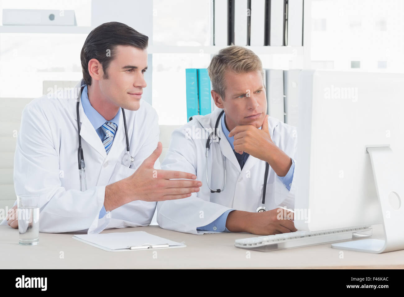Concentrated doctors working with computer Stock Photo - Alamy
