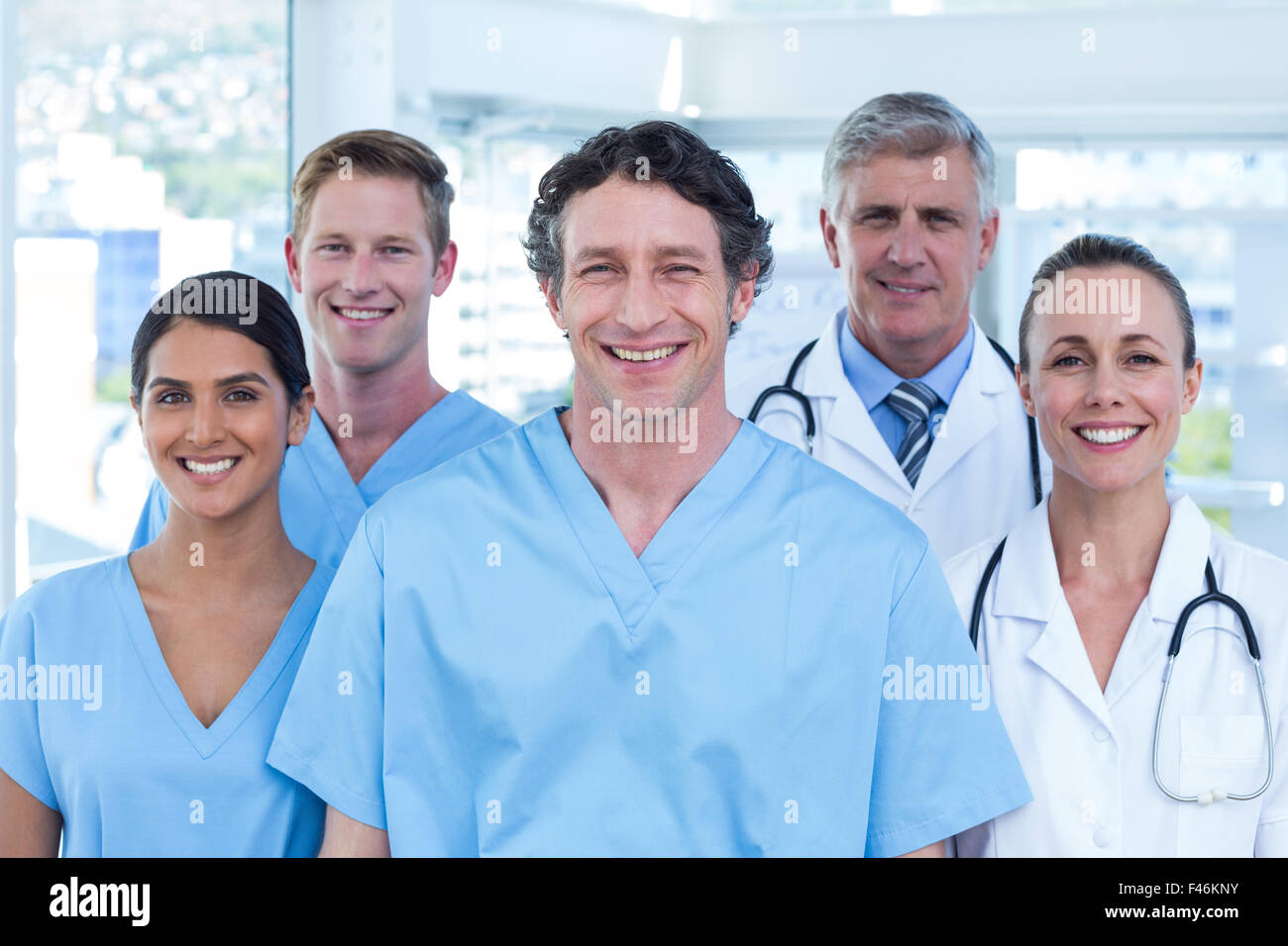 Team of doctors smiling at camera Stock Photo - Alamy