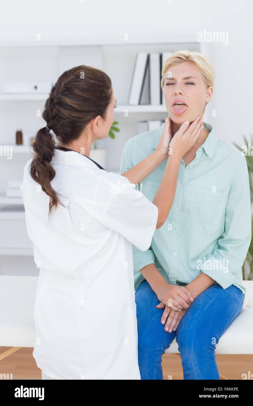 Doctor examining patient with neck ache Stock Photo - Alamy