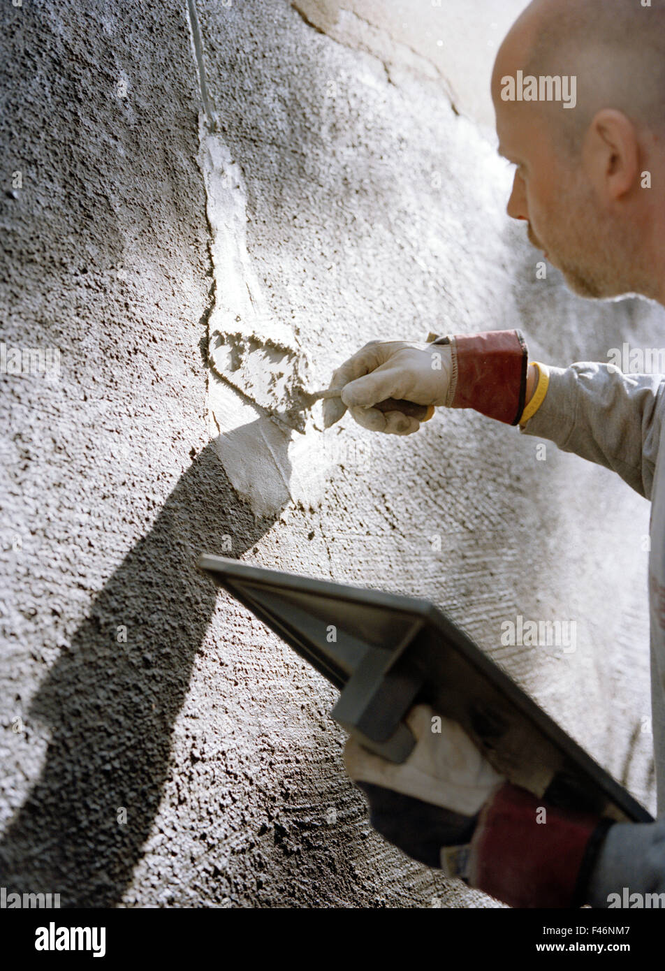 A man building a wall, Uppsala, Sweden Stock Photo - Alamy