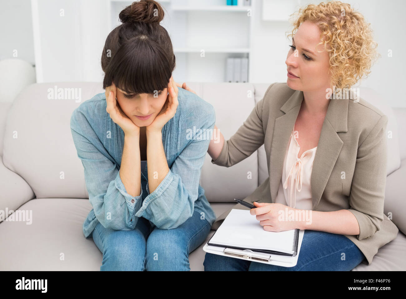 businesswoman comforting her colleague Stock Photo - Alamy