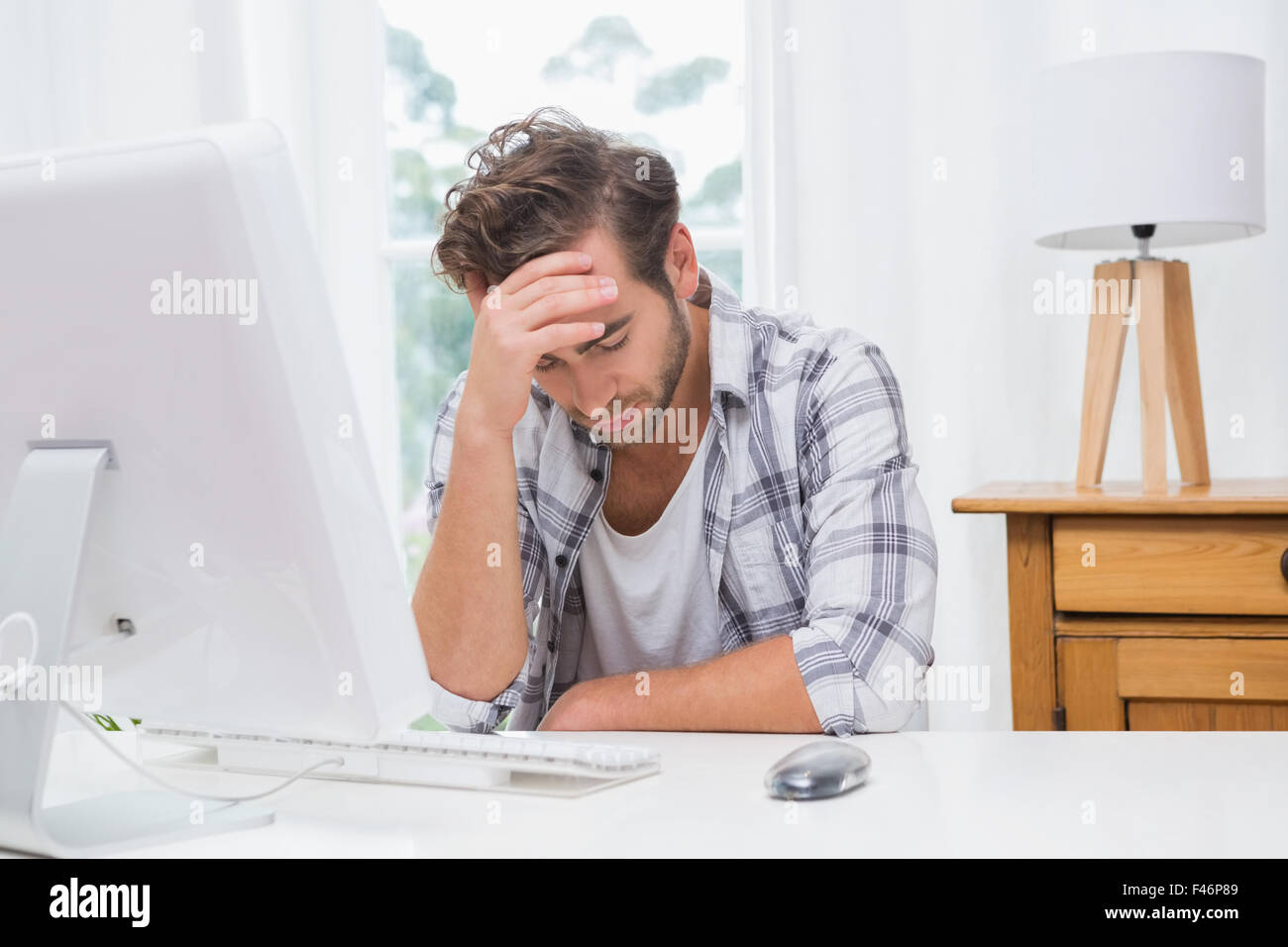 Handsome man sleeping behind computer Stock Photo - Alamy