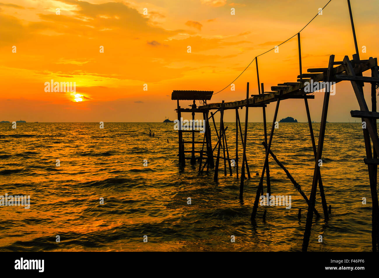 Jetty with sunset background Stock Photo - Alamy