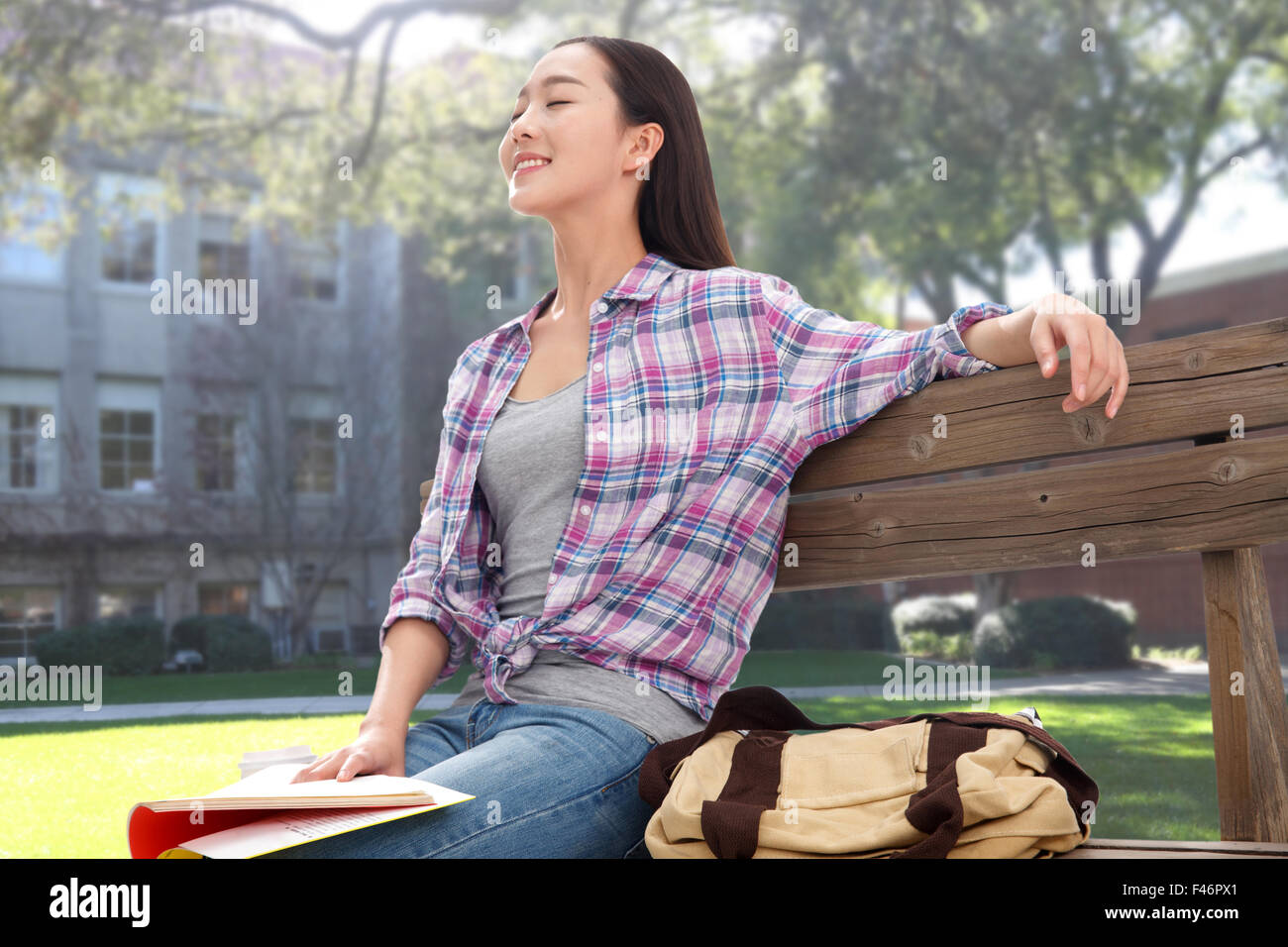 Portrait of college student sitting on bench Stock Photo - Alamy